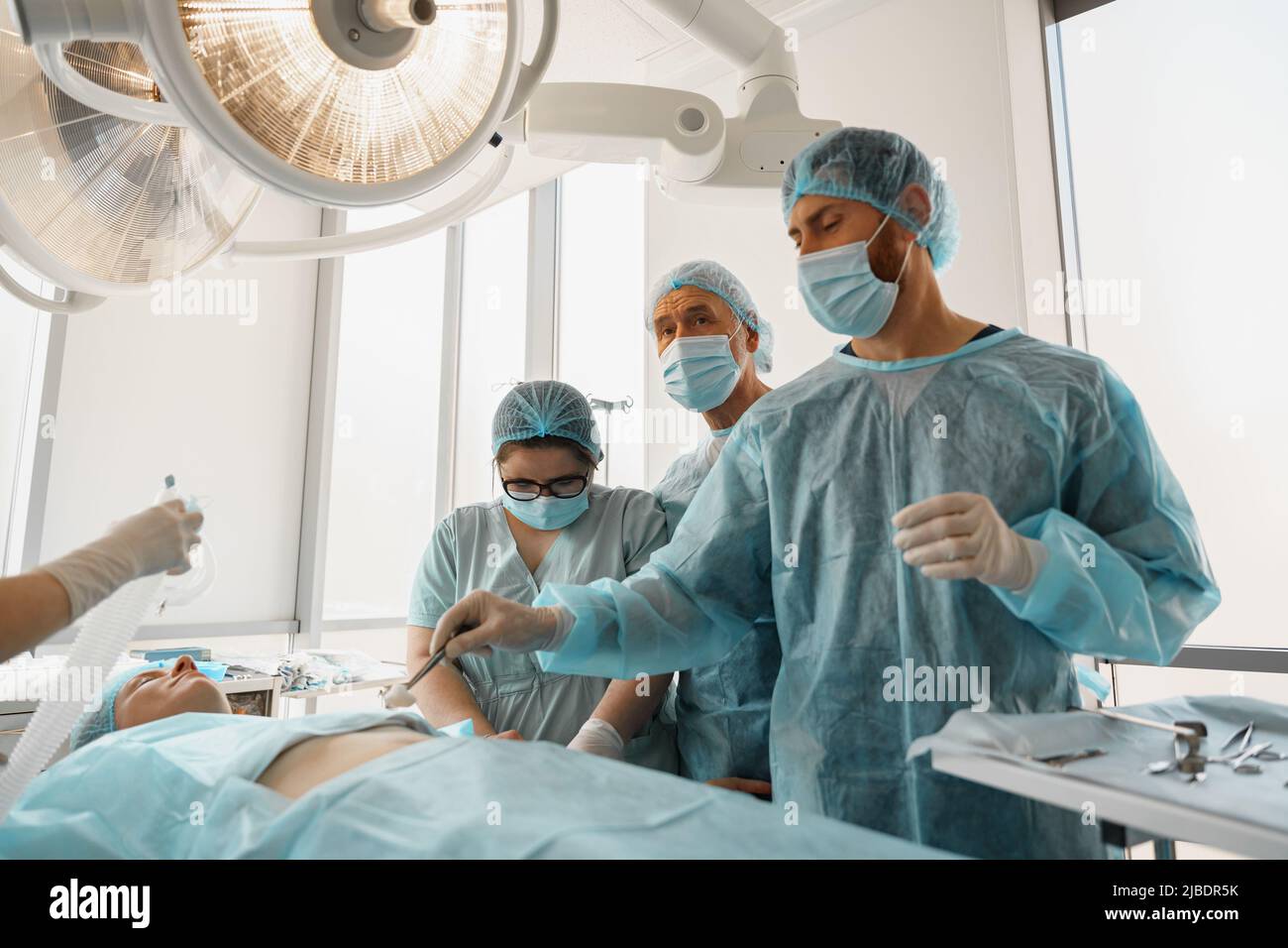 Nurse and doctor prepare patient skin for surgery using antiseptic ...