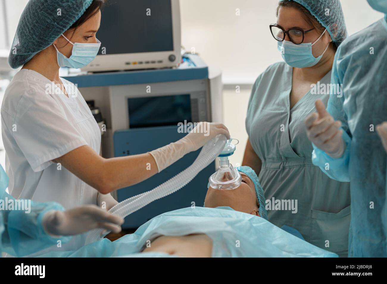 Well-trained anesthesiologist follows the patient during the surgery in ...