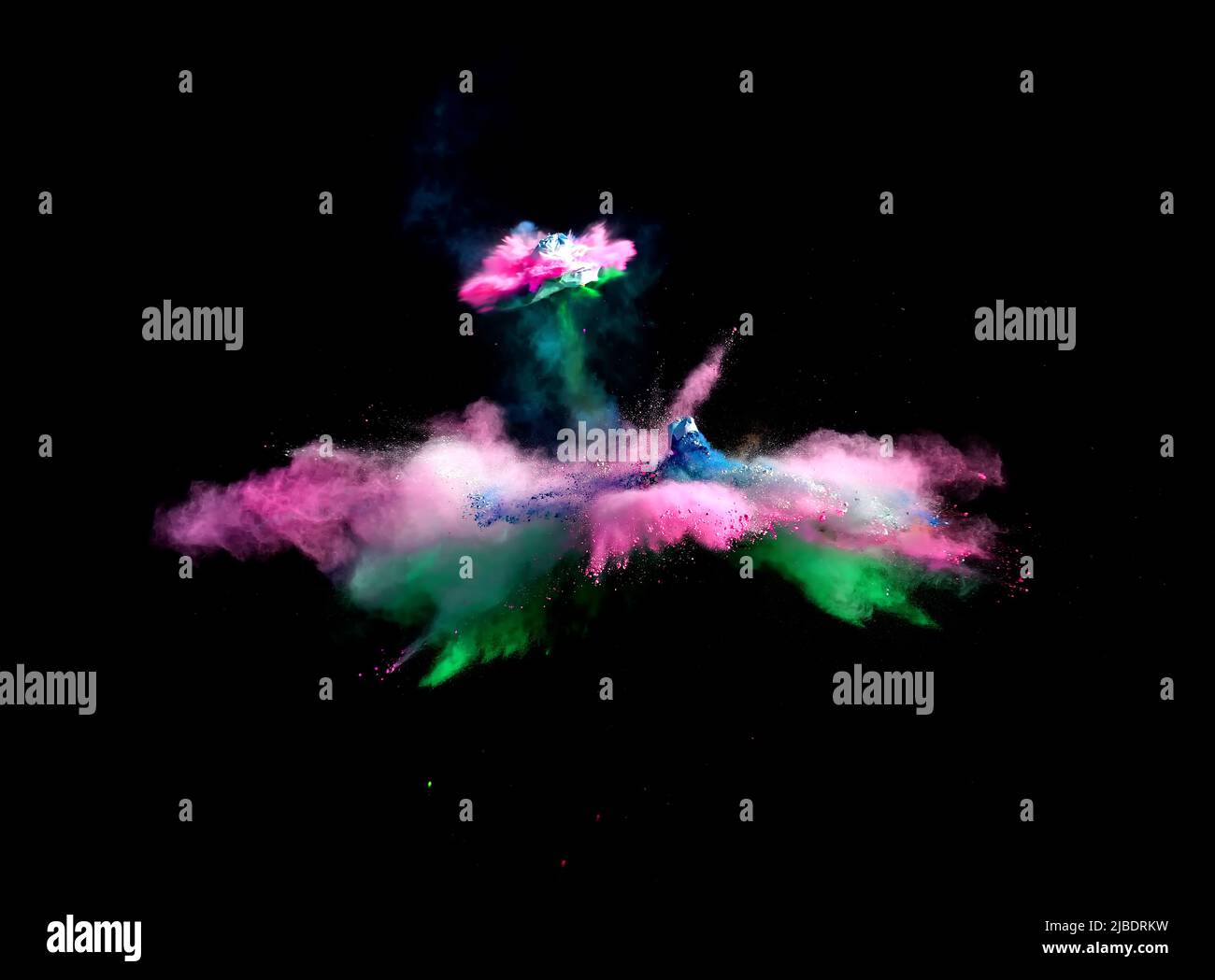 Various multicolored forms of powder paint explode in front of a black ...