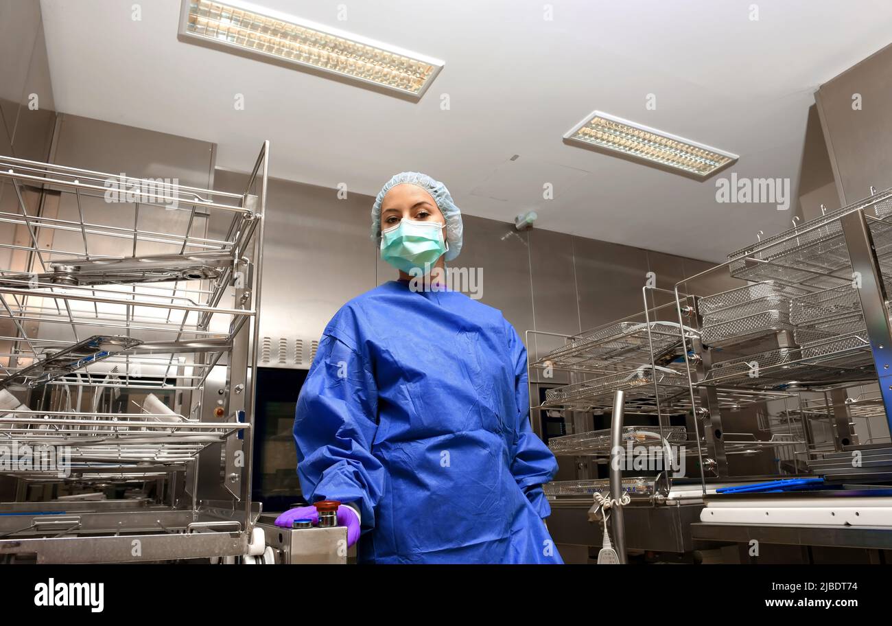 A girl works in a hospital as a medical hygiene worker. Dressed in ...