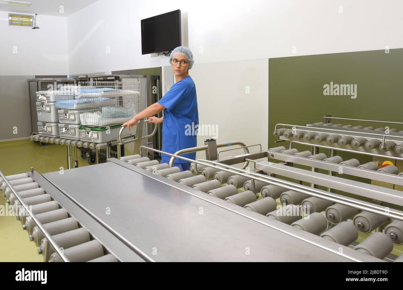 A girl works in a hospital as a medical hygiene worker. Dressed in ...