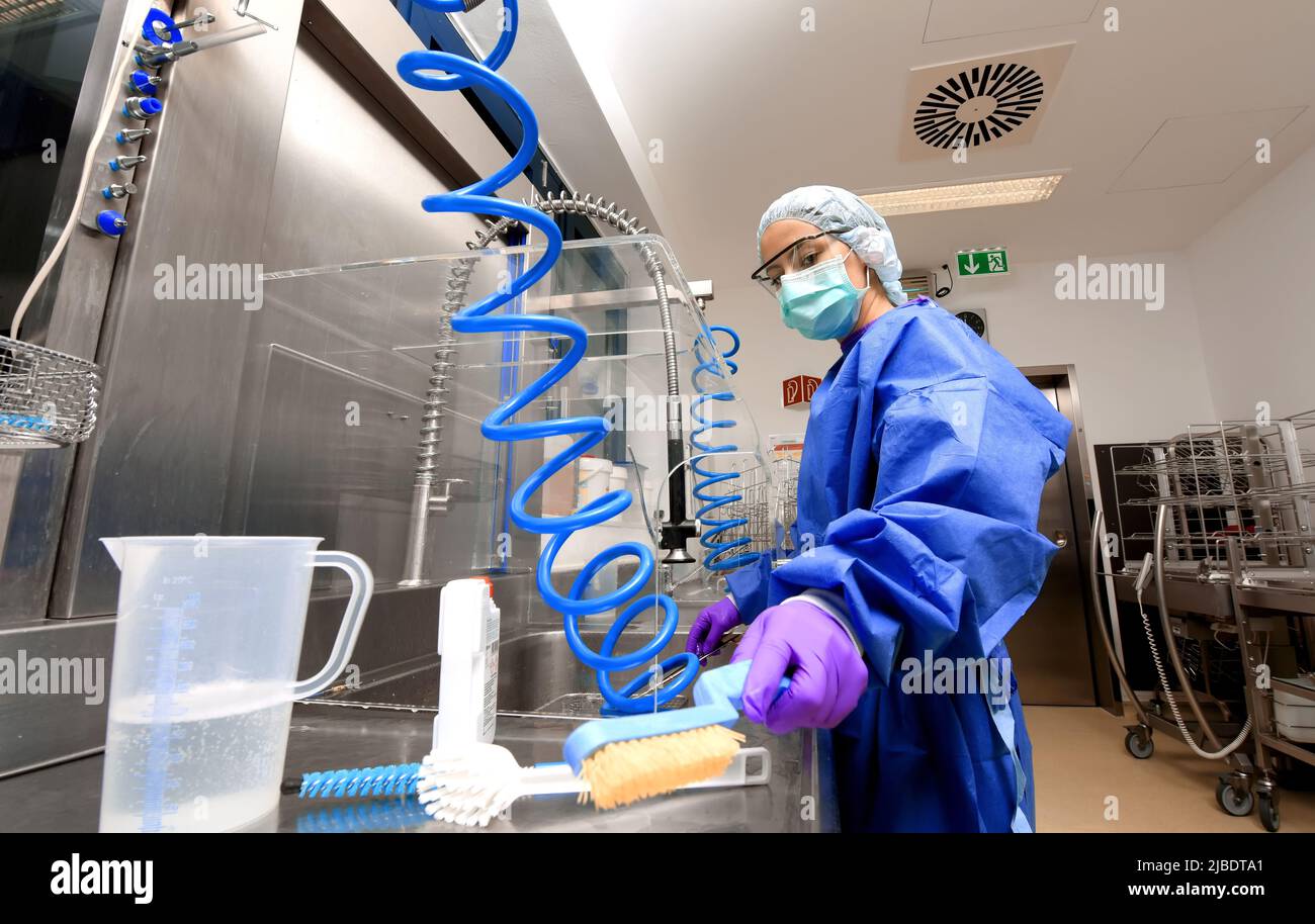 A girl works in a hospital as a medical hygiene worker. Dressed in ...