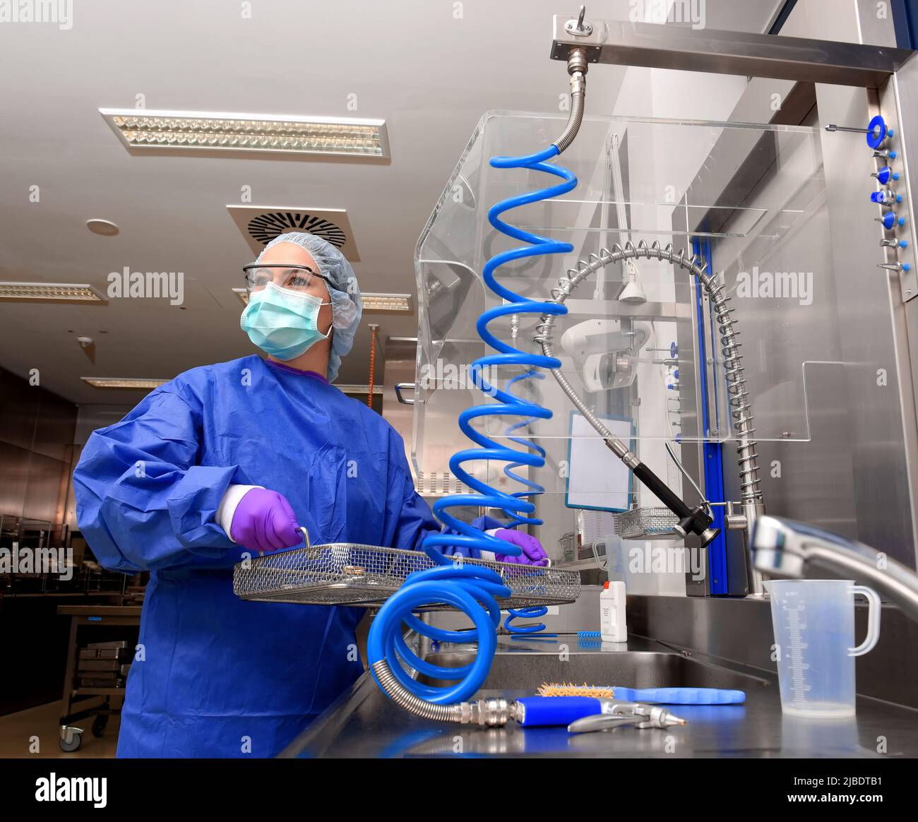 A girl works in a hospital as a medical hygiene worker. Dressed in ...