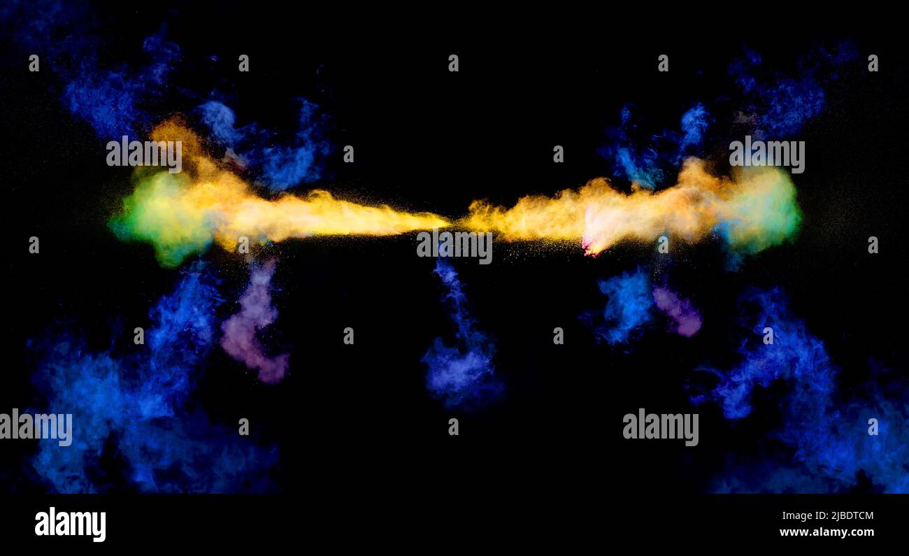 Various multicolored forms of powder paint explode in front of a black ...