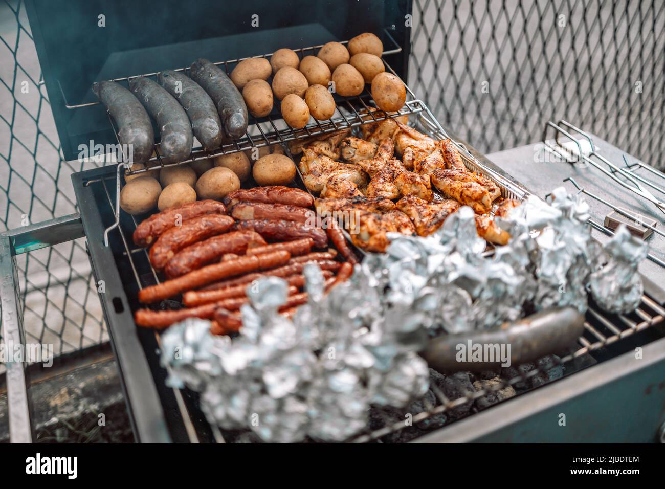 Close up view of men hands roasting barbecue on fire grill Stock Photo ...