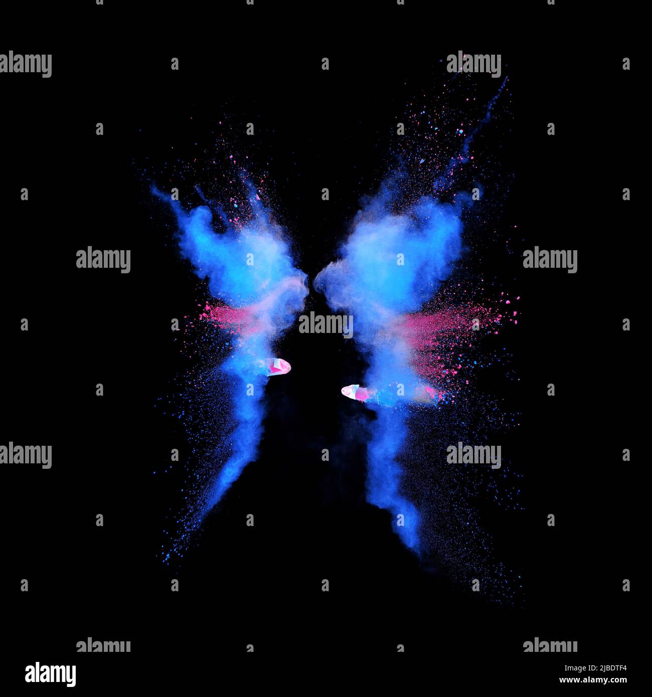 Various multicolored forms of powder paint explode in front of a black ...