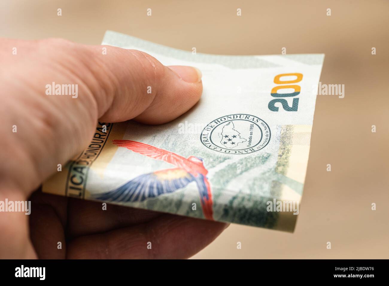 hand holding 200 Lempiras banknote in front of him, Honduras, financial ...