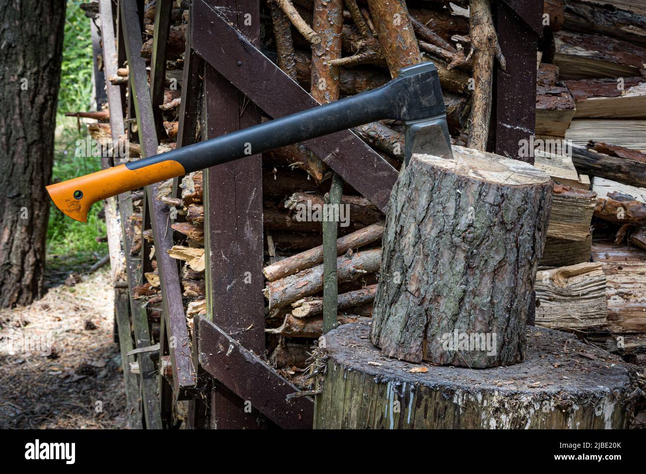 An axe driven into a stump. Preparing firewood. Chopping wood on a ...