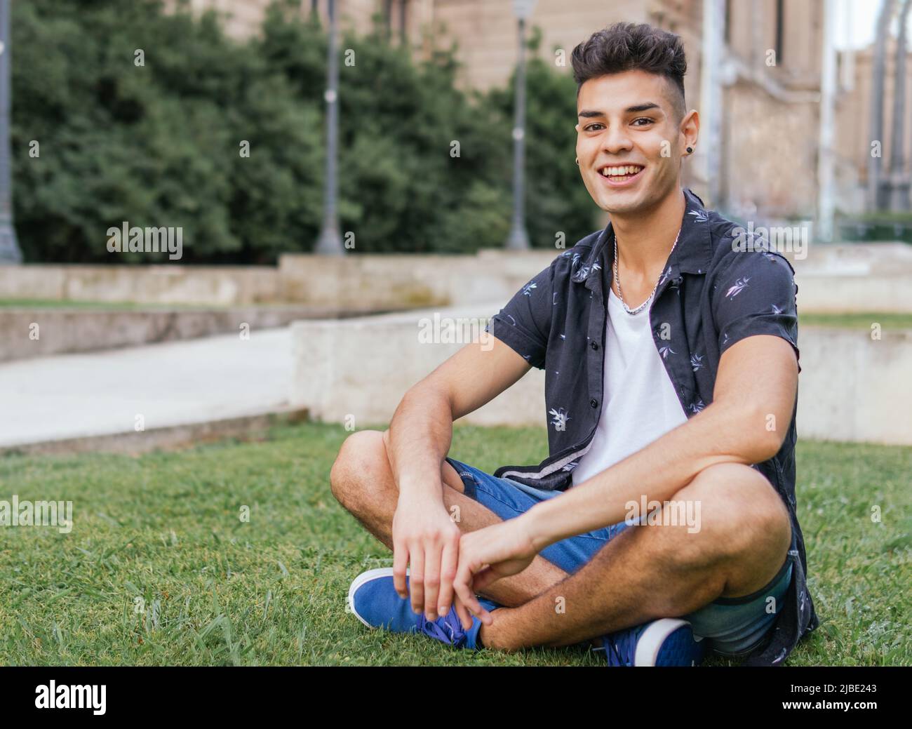 College male sitting cross legs hi-res stock photography and images - Alamy