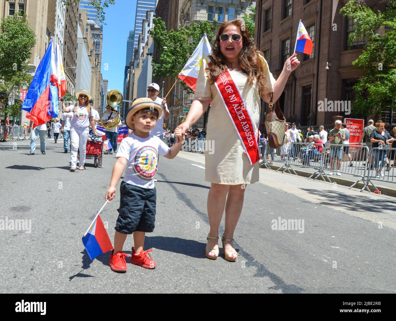 A young participant march up Madison Avenue holding Philipiones flag in ...