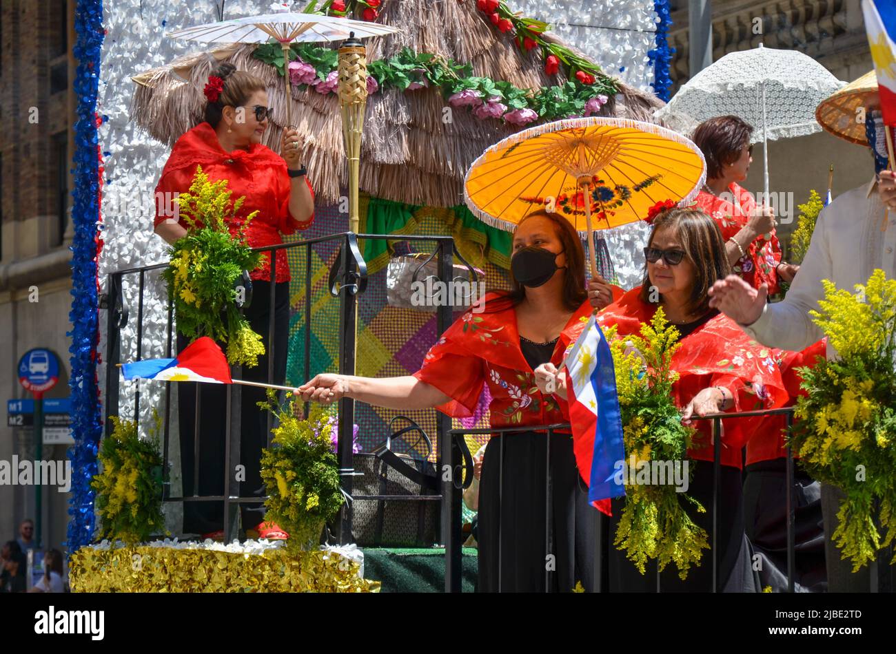 Participants on a float march up Madison Avenue holding Philipiones ...