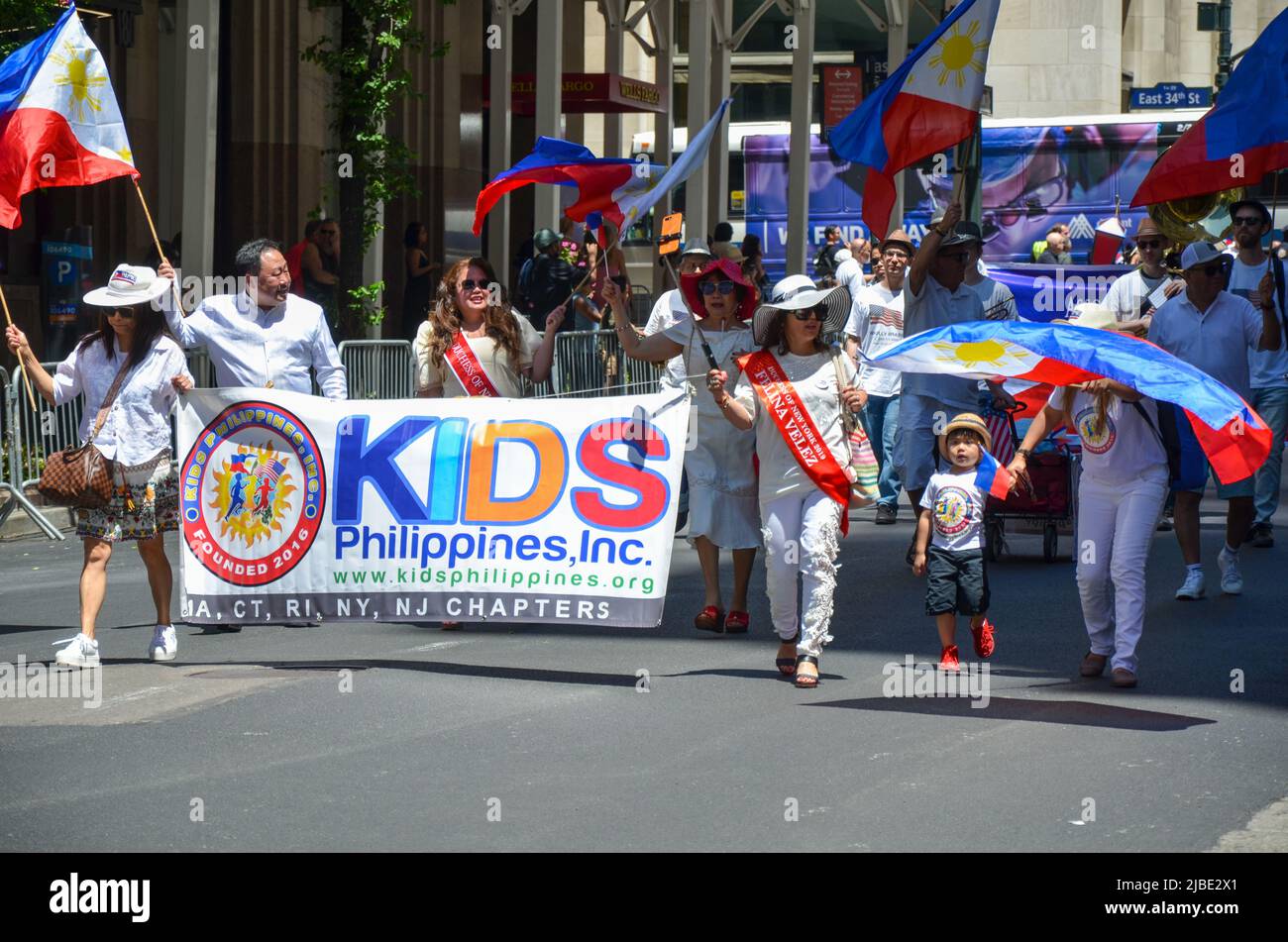 Participants march up Madison Avenue holding Philipino flag in New York ...