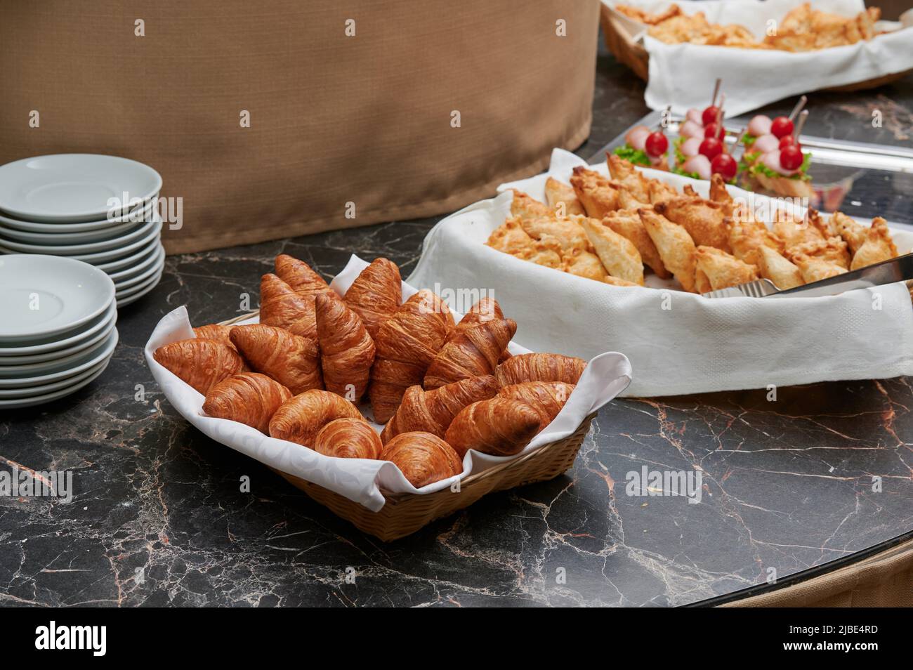 puff pastry pastries on a buffet table bagels on a tray in a cafe Stock ...