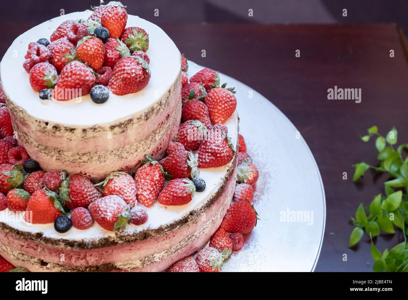 Two-tiered original cake with lots of strawberries Stock Photo - Alamy