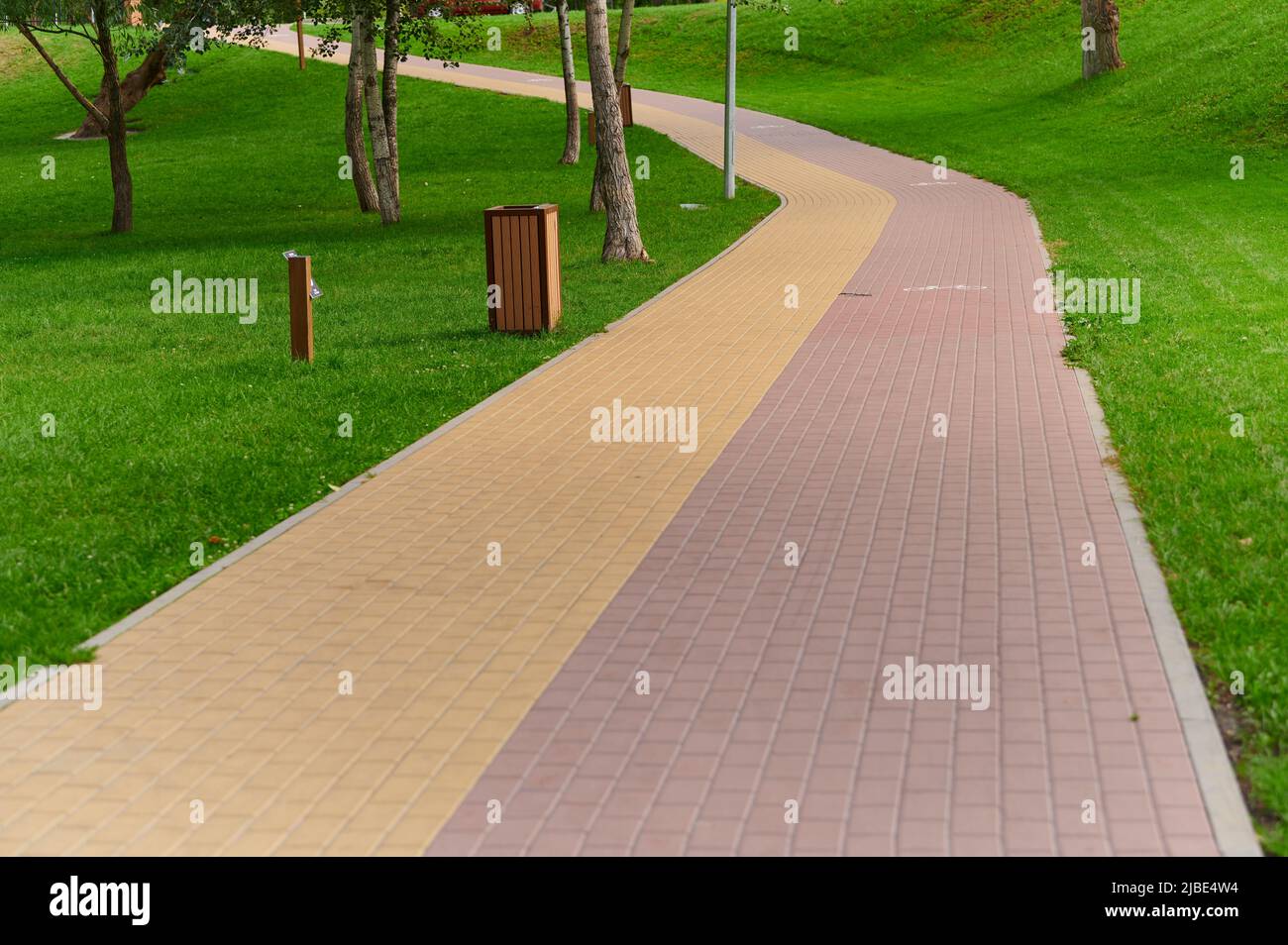 Pedestrian sidewalks made of colored stone in public places and bike ...