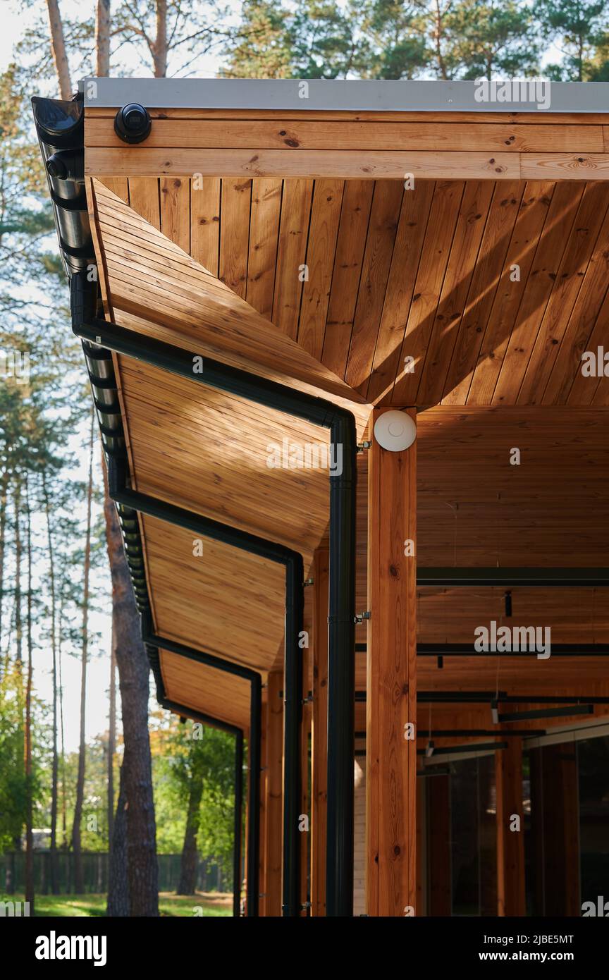 The roof of an open veranda made of wood trim with plastic pipes for ...