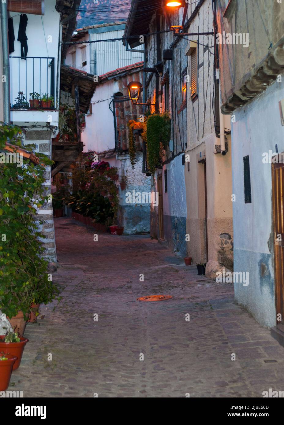 Street of the Jewish neighborhood of Hervas at dusk, street with pots ...