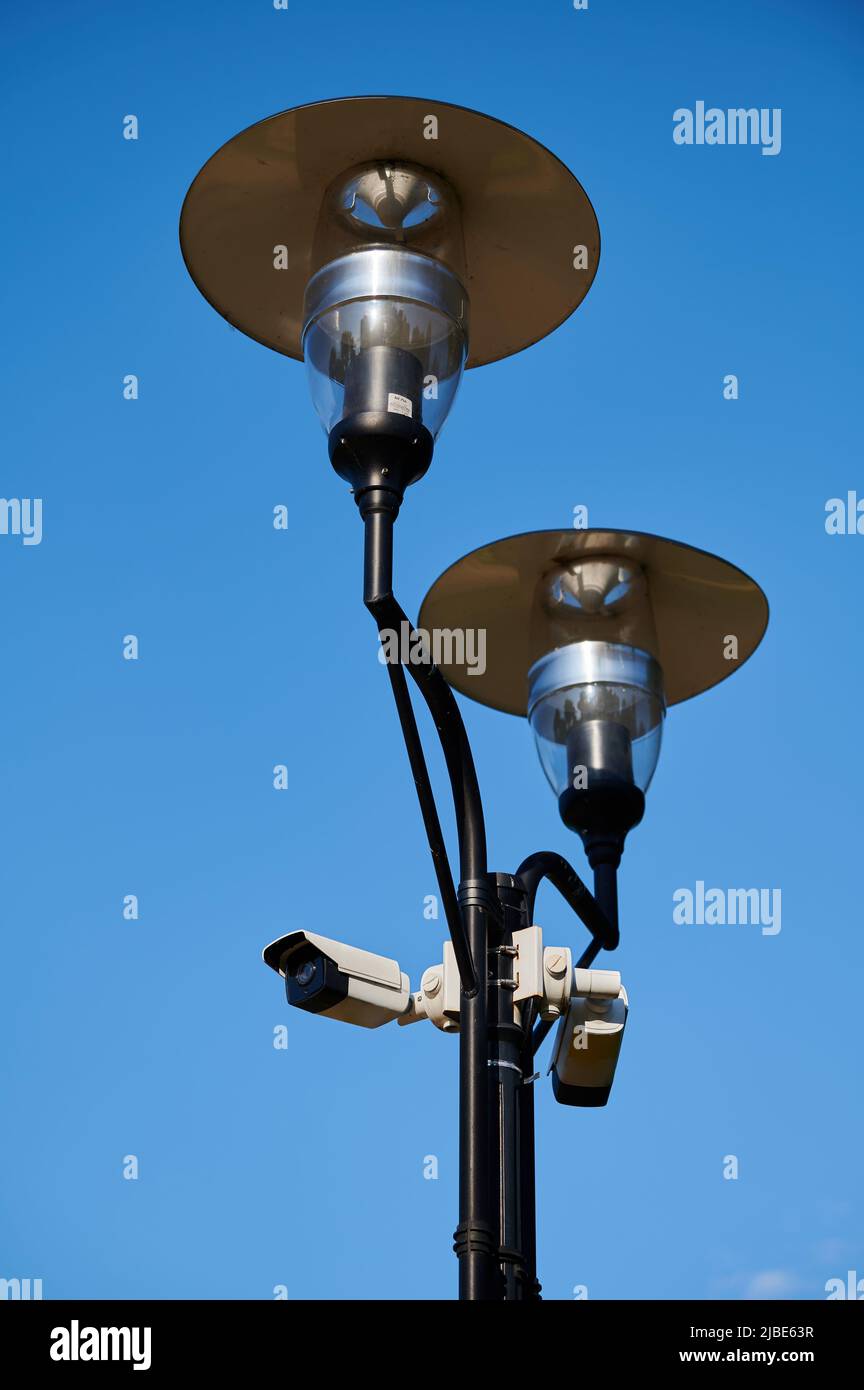 street lamppost with installed video surveillance cameras in the city ...