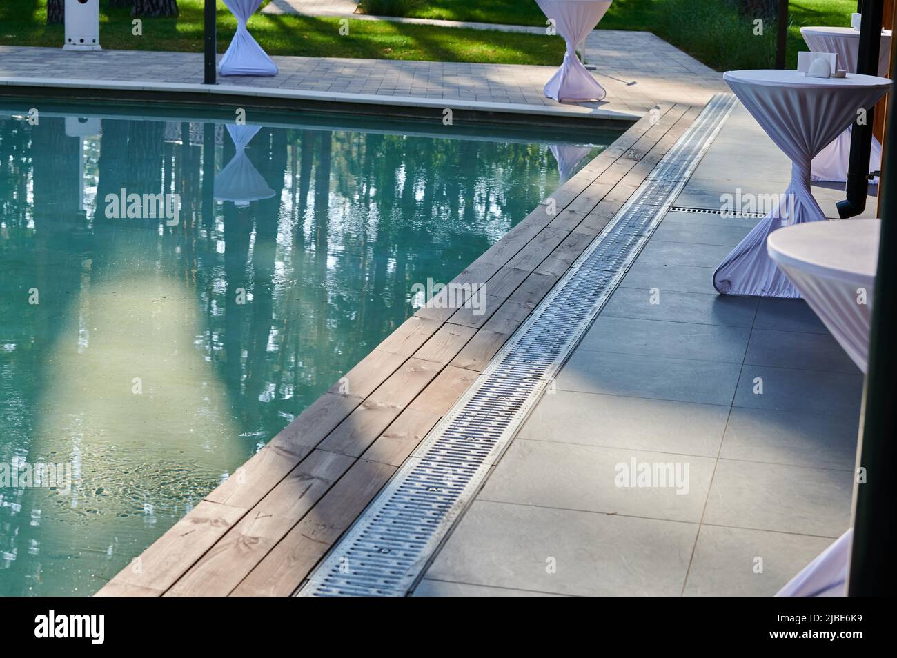 drains around the outdoor pool in the spa center on the street under ...