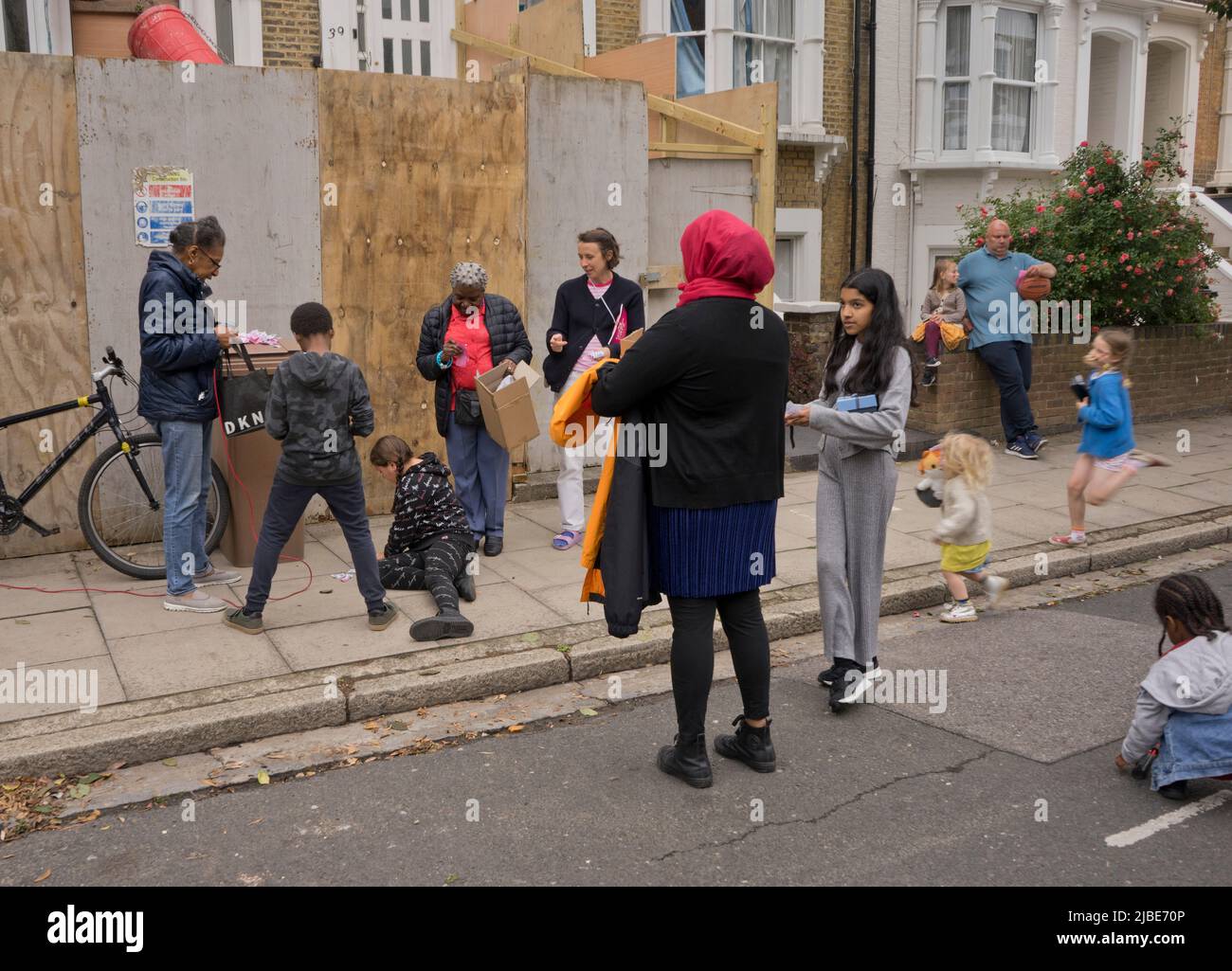 Neighbours at a community street party to commemorate Queen Elizabeth ...