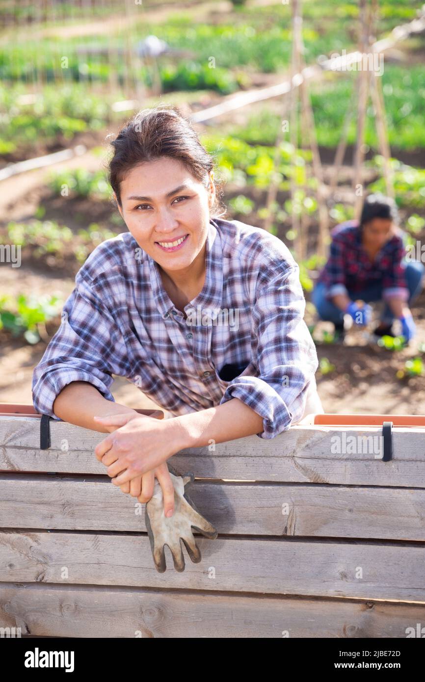 Positive female gardener posing in backyard garden Stock Photo - Alamy