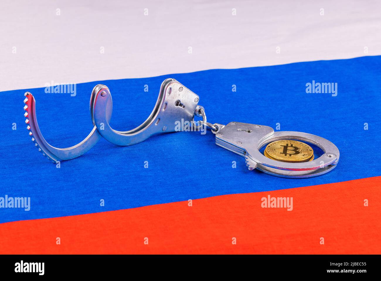 bitcoin shiner chained with handcuffs on russian flag background ...