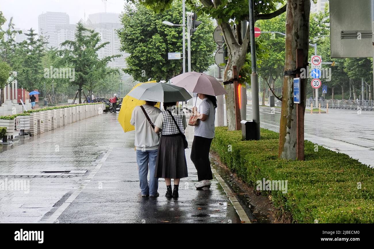 SHANGHAI, CHINA - JUNE 5, 2022 - People travel in the rain in Shanghai ...
