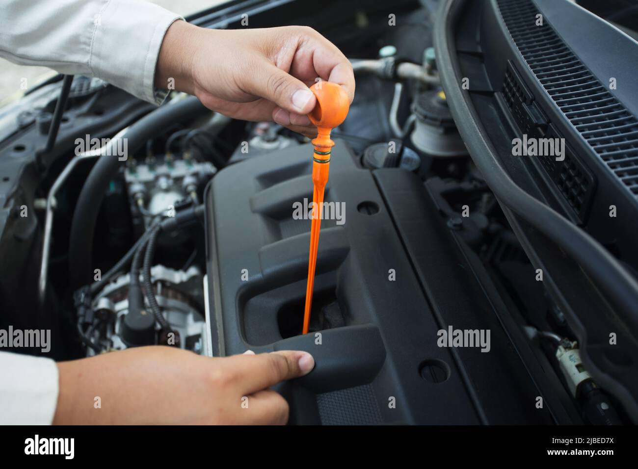 Car mechanic check oil level Stock Photo - Alamy