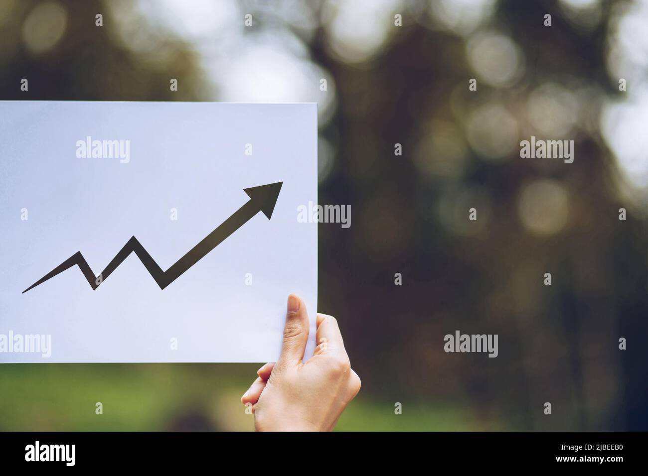Show business paper graph statistics,arrow showing the chart in hand on ...