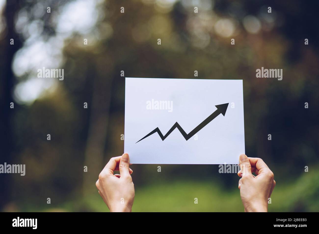 Show business paper graph statistics,arrow showing the chart in hand on ...