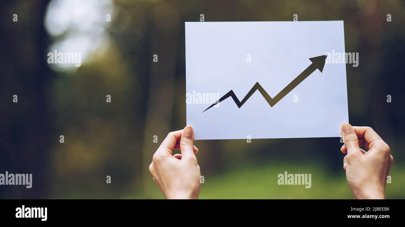 Show business paper graph statistics,arrow showing the chart in hand on ...