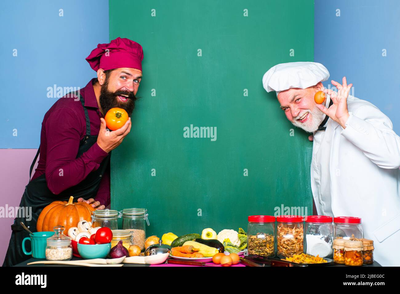 Cooking, profession, advertisement and people concept. Two chef cook ...