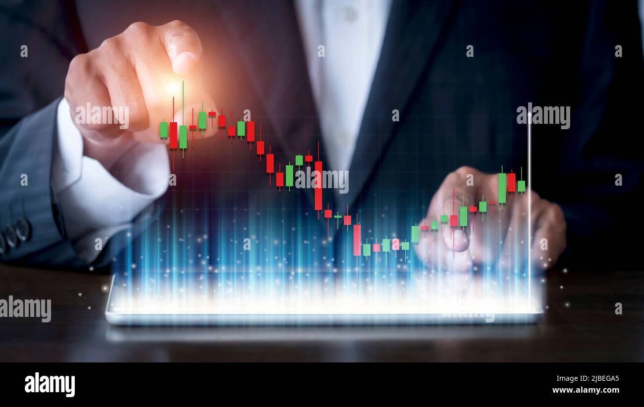 Hand of businessman use tablet analysis stock market graph growth and ...