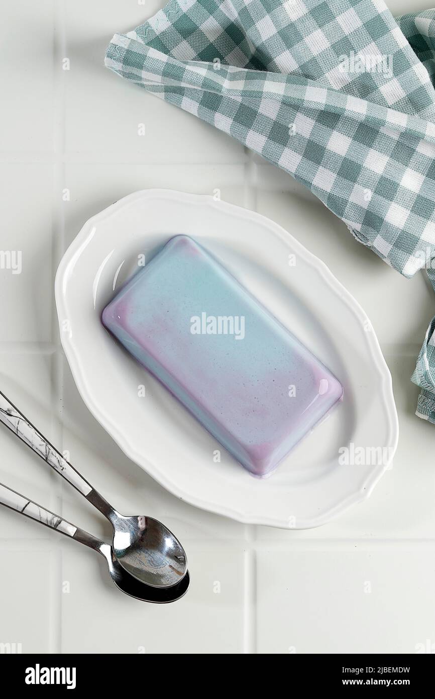 Bubblegum Pudding on White Plate. HOmemade Soft Silky Pudding with Blue ...