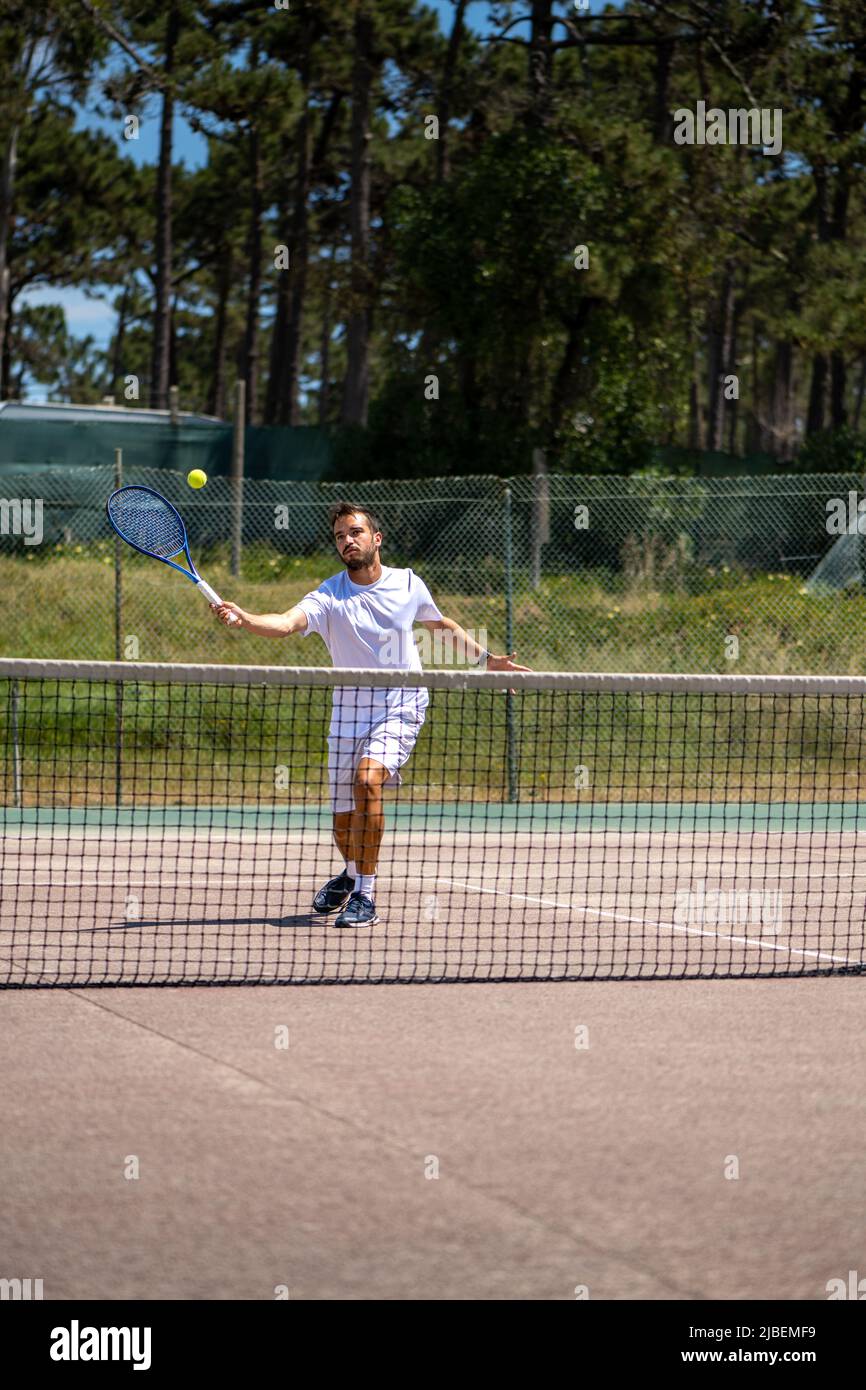 Tennis player performing a drop shot on court Stock Photo - Alamy