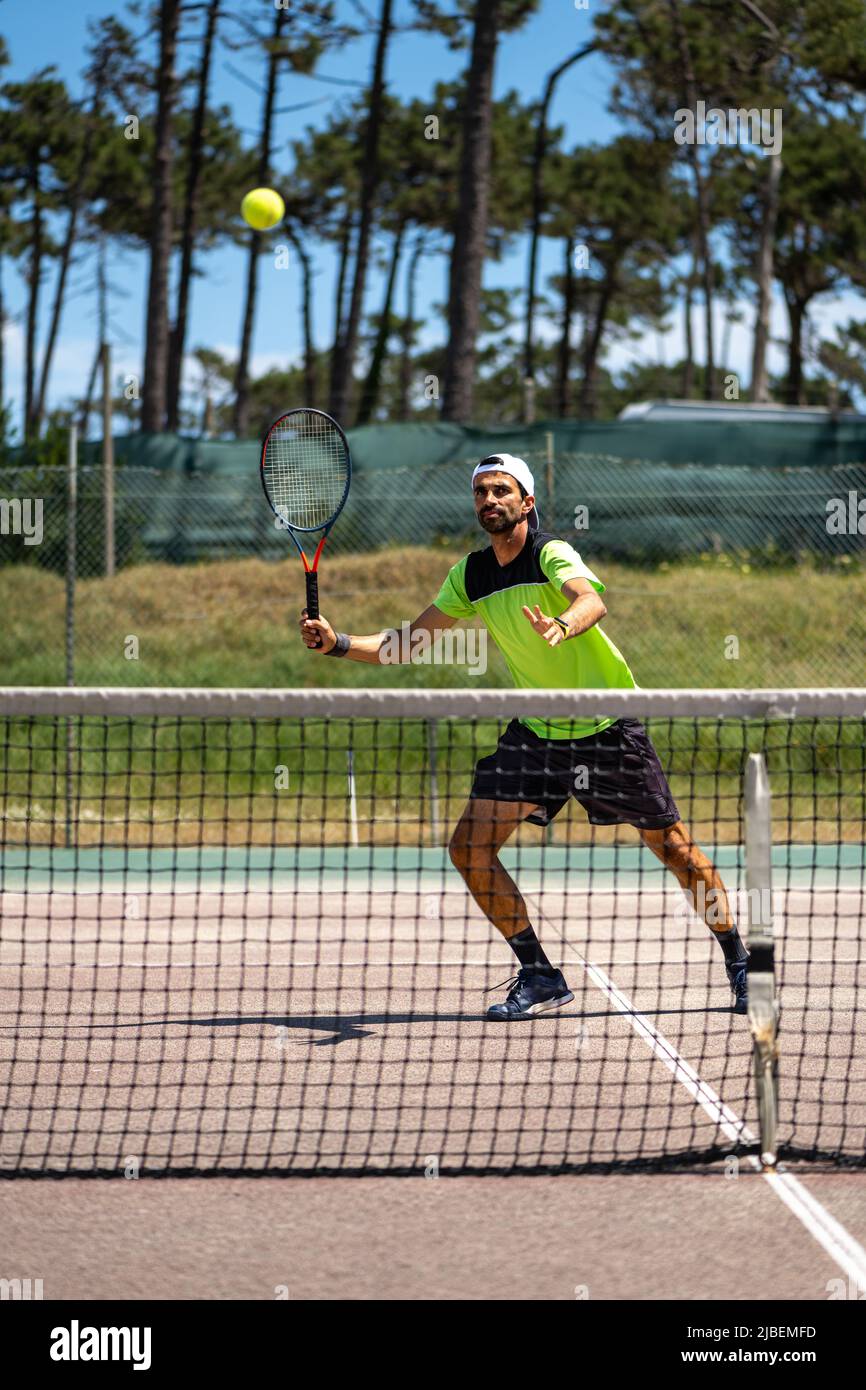 Tennis player performing a drop shot on court Stock Photo - Alamy