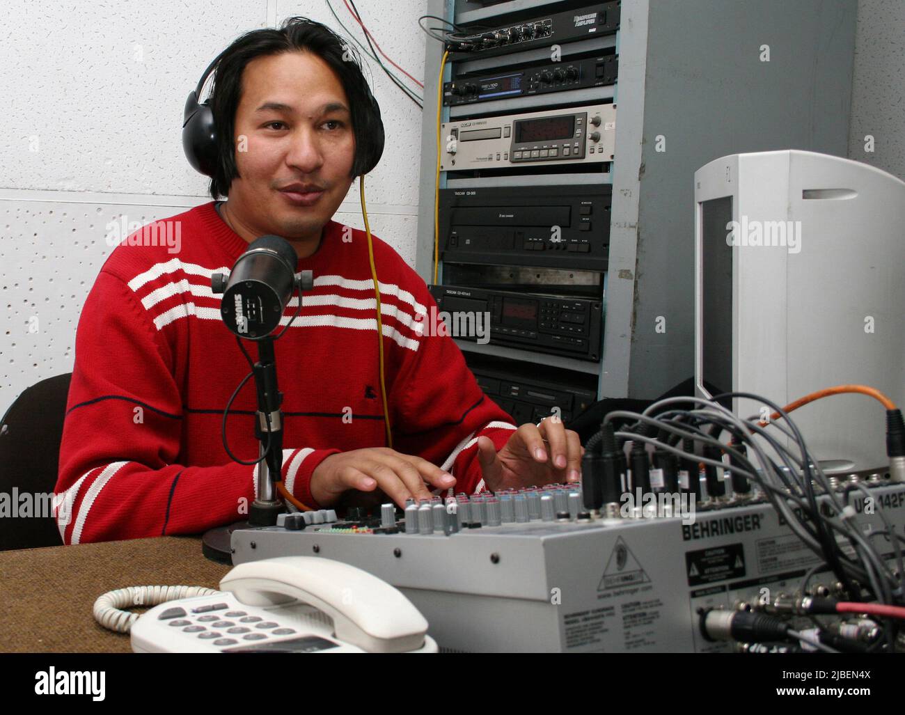 A male radio presenter working at a radio station. Bangladesh Stock ...