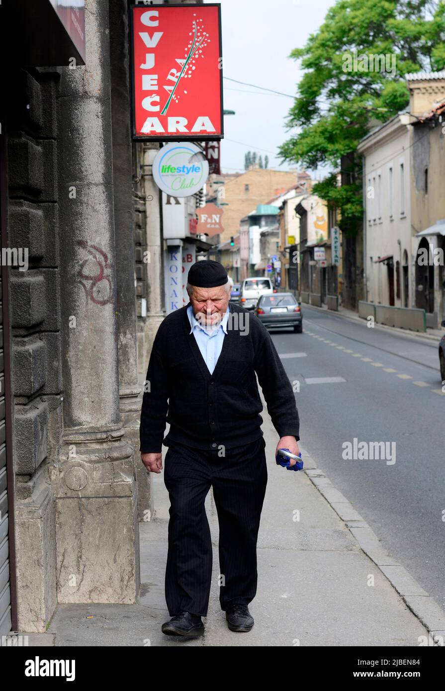 A Bosnian man walking on Mula Mustafe Bašeskije , Sarajevo , Bosnia ...