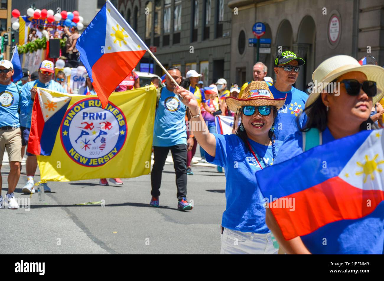 Participants march up Madison Avenue holding Philipiones flag in New ...