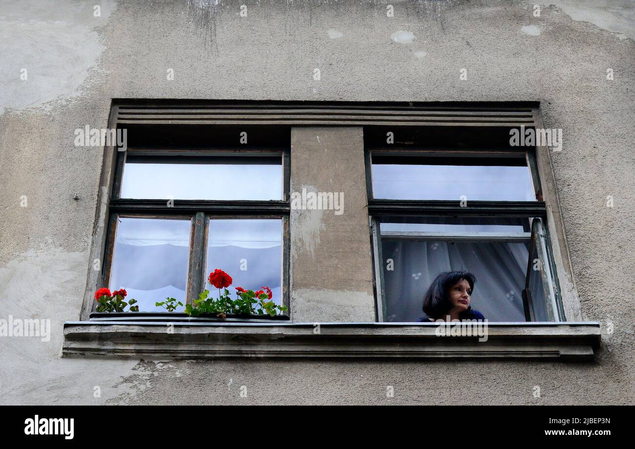 Good morning Sarajevo. A Bosnian woman looking out through her home ...