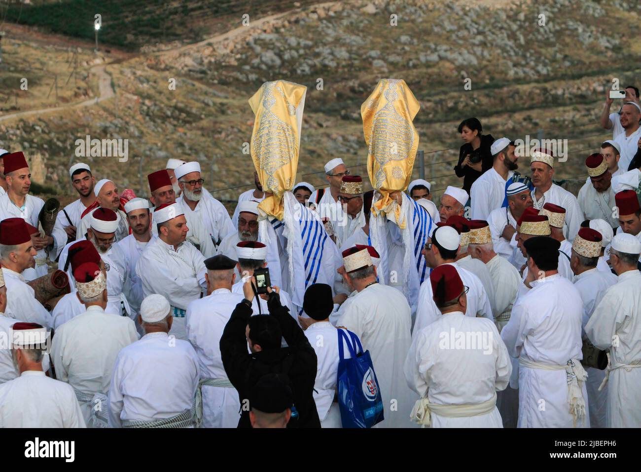 Members of the ancient Samaritan community carry the ancient book of ...