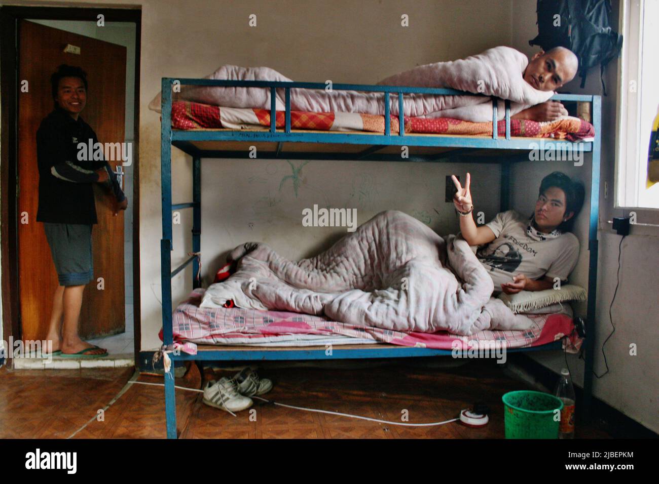 Men relaxing on a bunk bed at a boarding house. Bangladesh Stock Photo ...