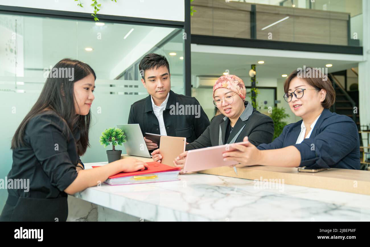 Group of Asian business people working together, meeting and in a ...