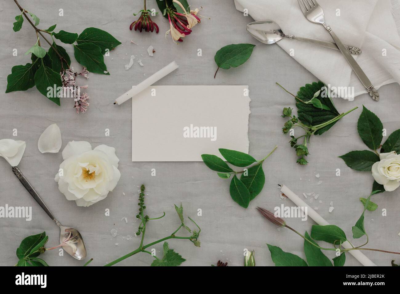 A beautiful white rose floral arrangement on a dinner table with ...
