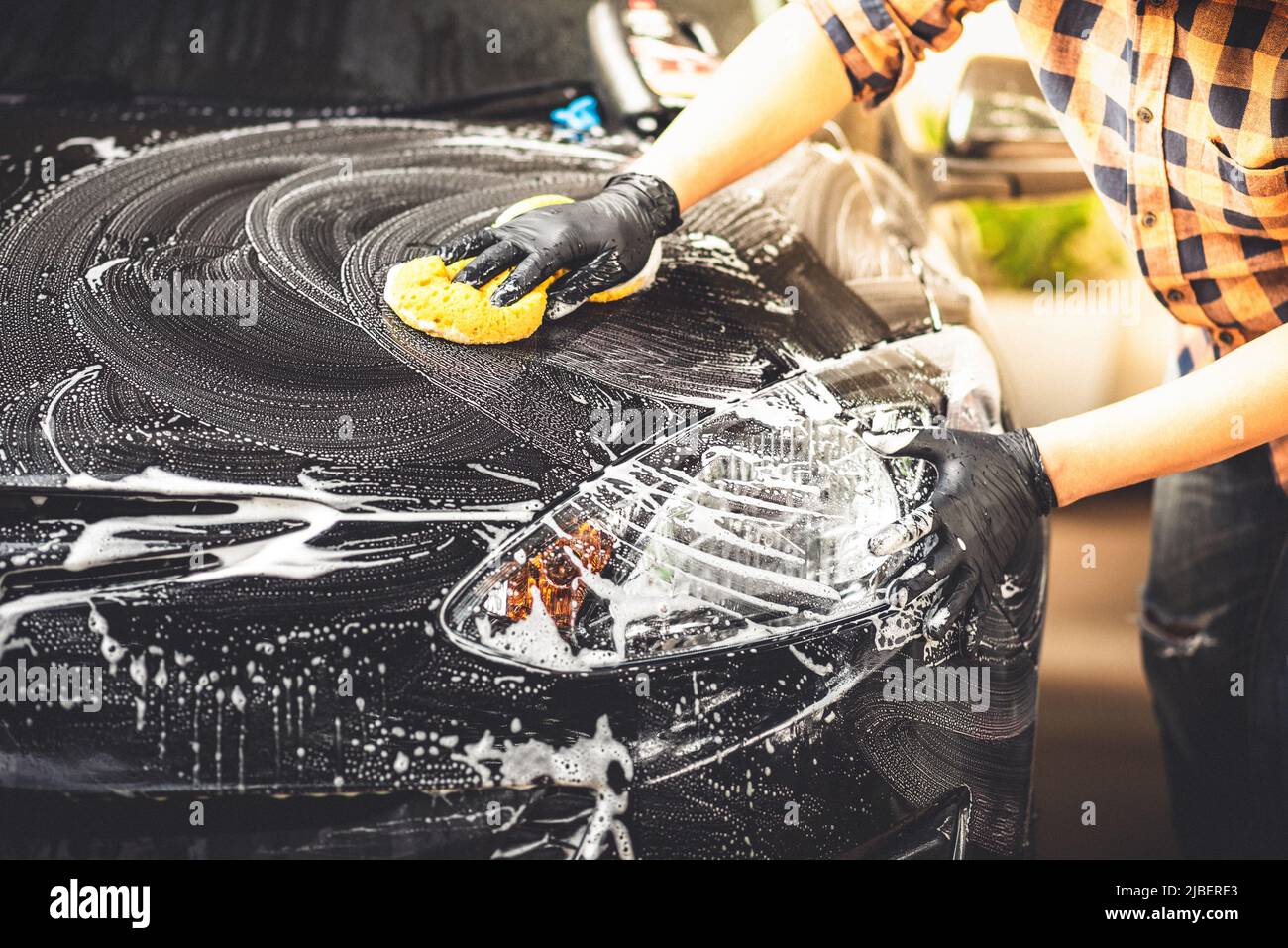 Washing the black car. Car cleaning and car care concept Stock Photo ...