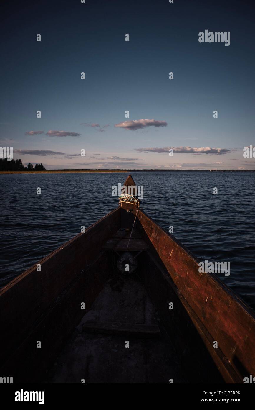 Front view of wooden boat nose sailing on calm lake during sunset Stock ...