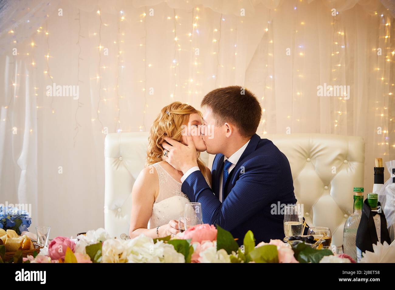 The bride and groom kissing during marriage ceremony at the registry ...