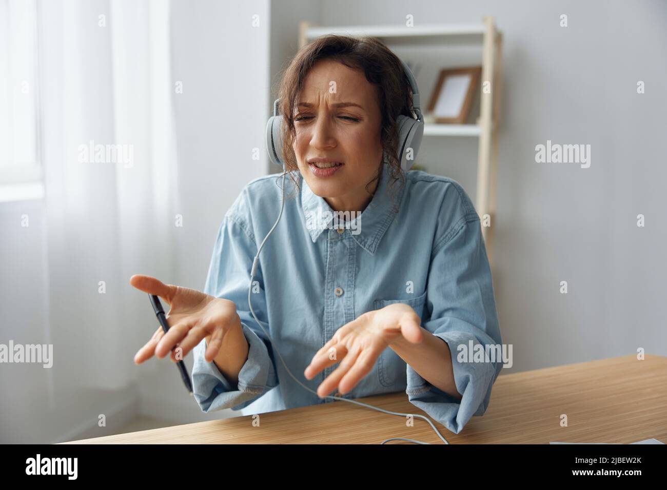 Irritated angry evil adorable cute curly lady in headphones active ...
