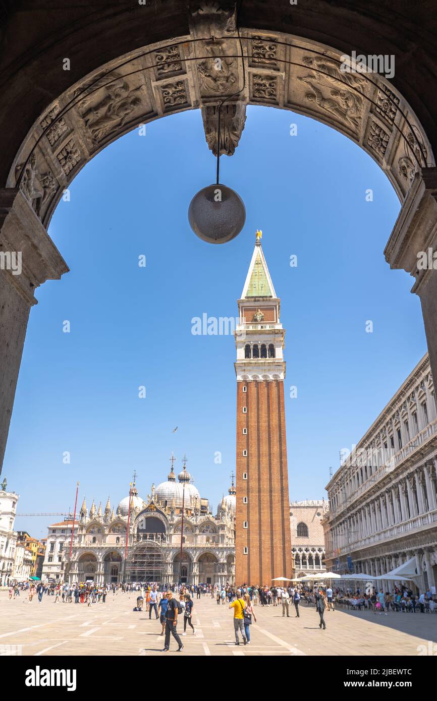 St Mark's Campanile and Basilica seen through archway in Venice, Italy ...