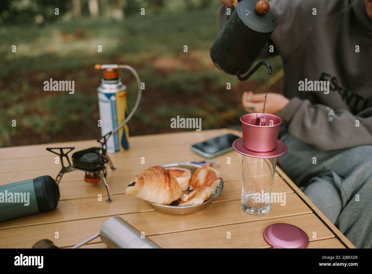 Coffee drip while camping in forest with sunshine. Coffee maker outdoor ...